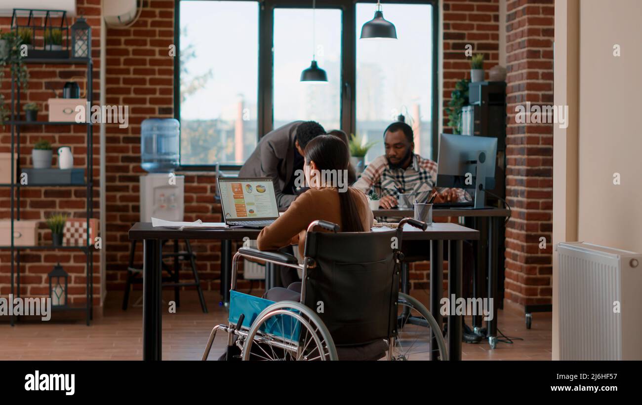 African american man helping woman in wheelchair with transportation ...