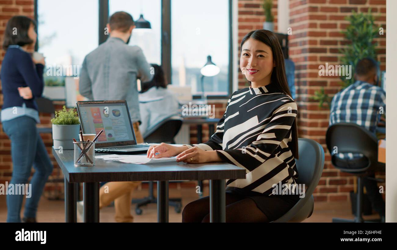 Portrait of asian HR employee analyzing cv information of candidates ...