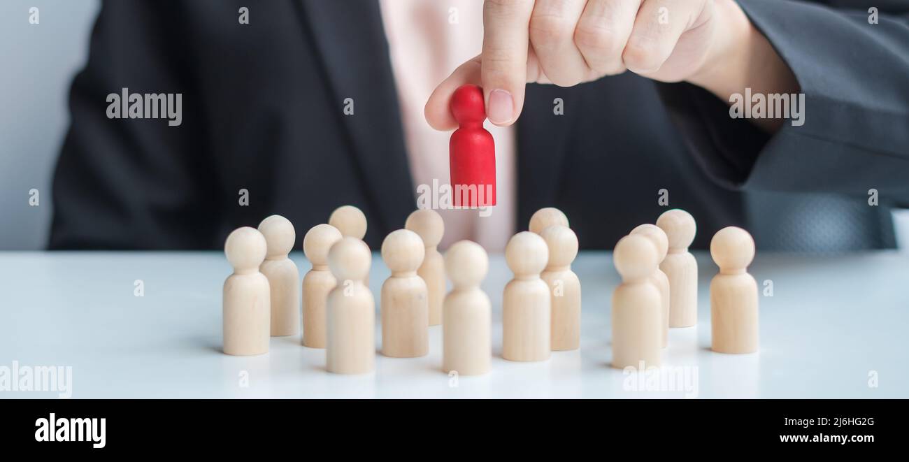 Businesswoman hand pulling leader man wooden from crowd of employees ...