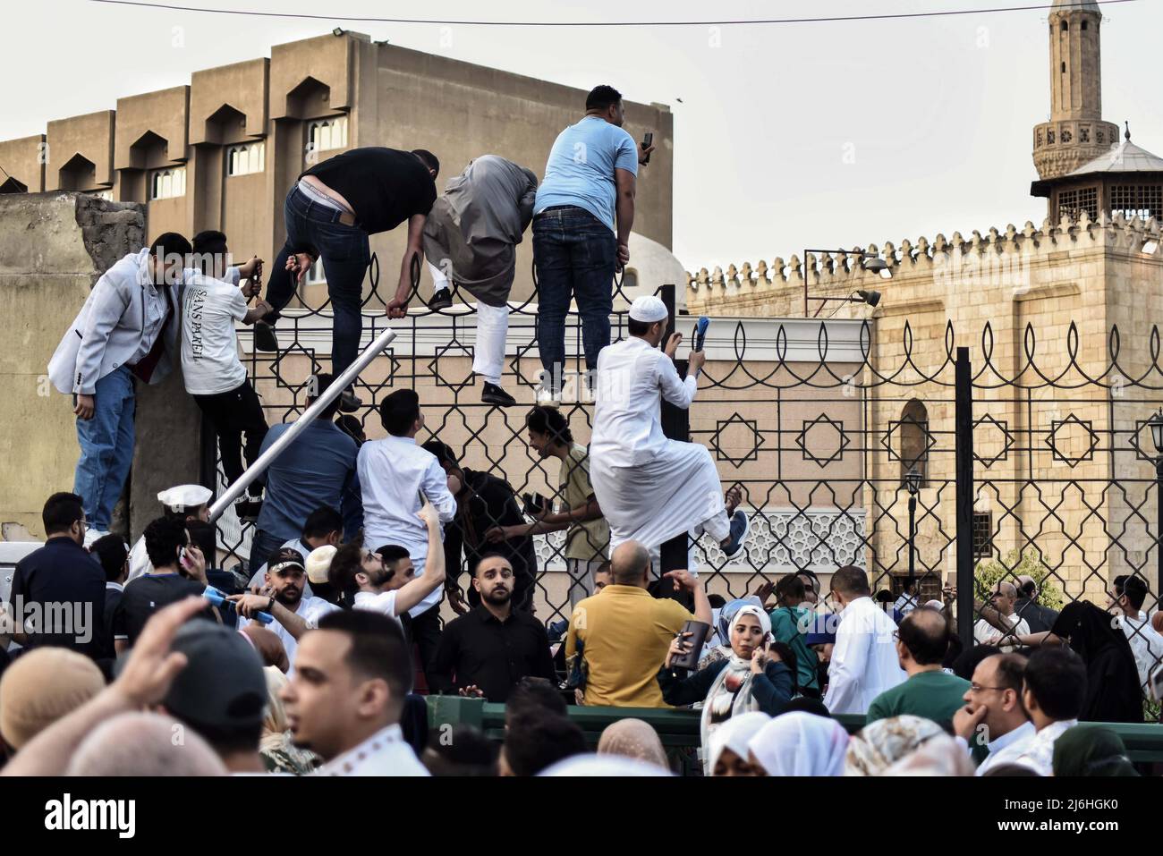 02 May 2022, Egypt, Cairo: People jump the fence outside Al-Azhar ...