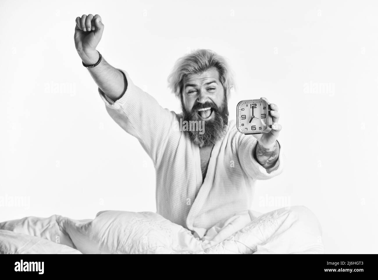 Healthy habits and lifestyle. Bearded man with alarm clock. Awakening ...