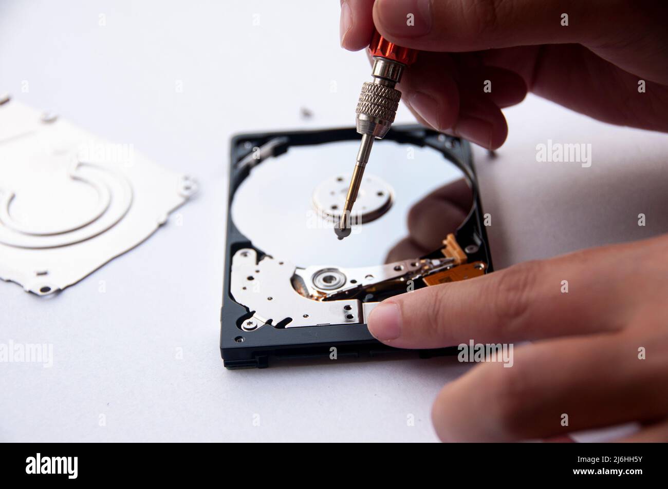 The abstract image of inside of hard disk drive with technician fixing ...