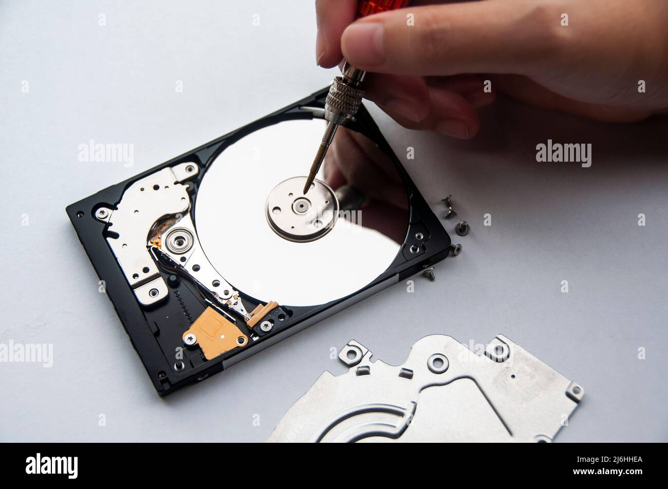 The abstract image of inside of hard disk drive with technician fixing ...