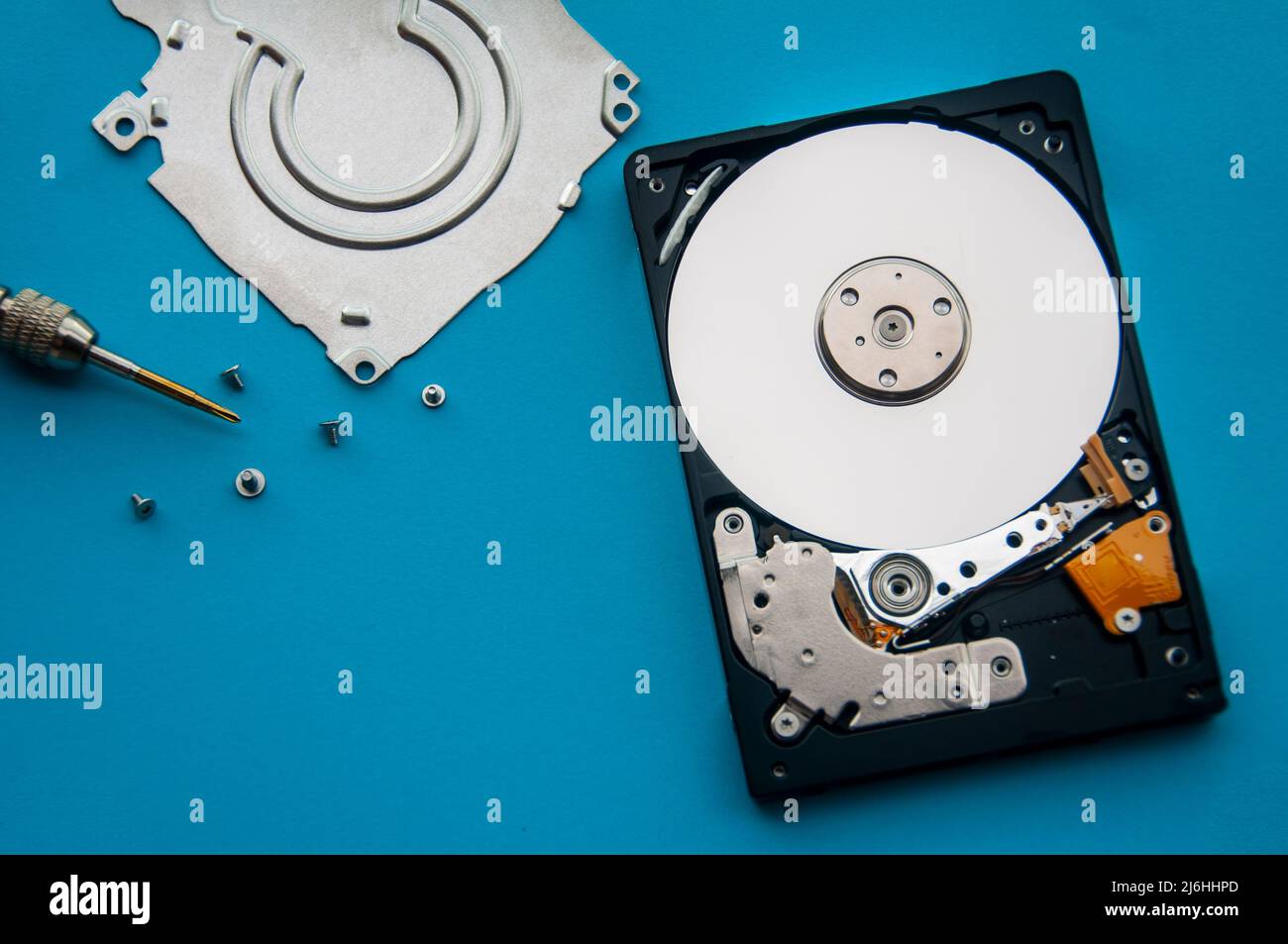 The abstract image of inside of hard disk drive on blue cover and screw ...