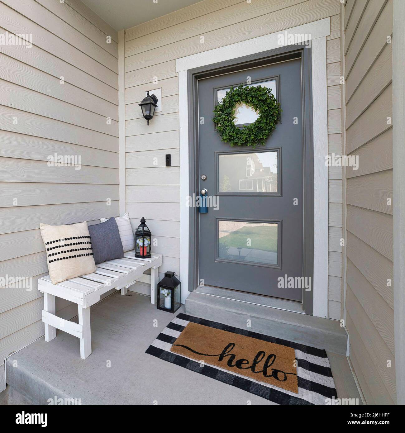 Square Small front porch with white bench and gray front door Stock ...