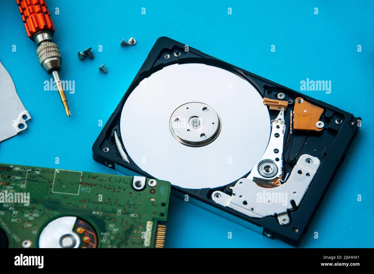 The abstract image of inside of hard disk drive on blue cover and screw ...