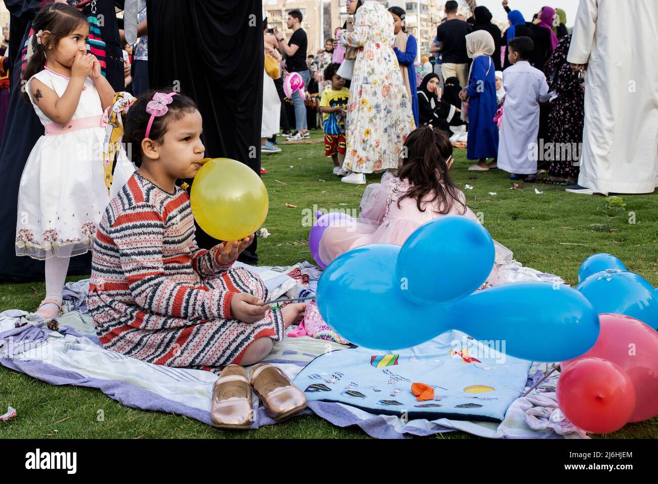 02 May 2022, Egypt, Cairo: Girls celebrate with balloons after Muslim ...
