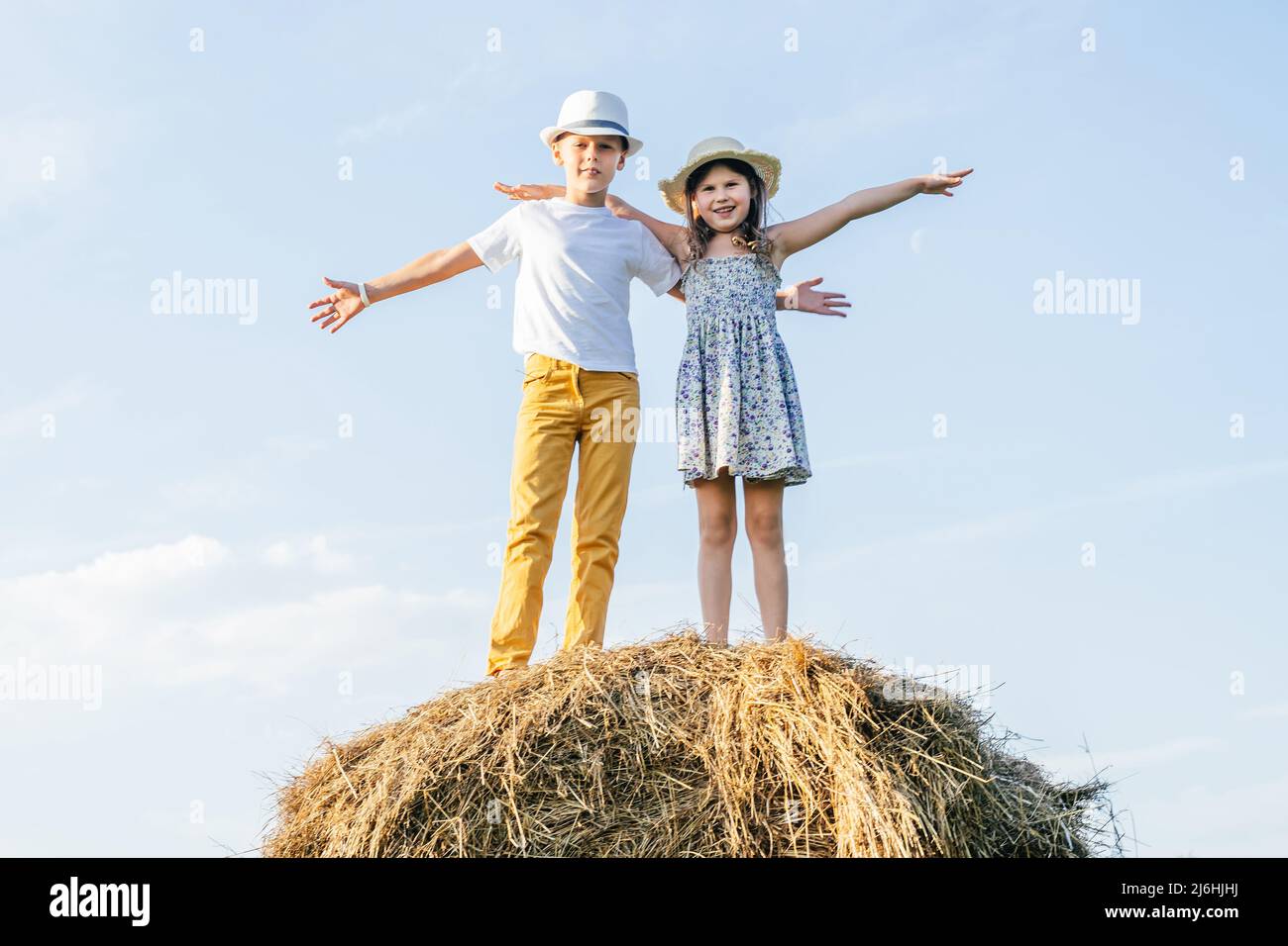 Portrait of children boy and girl staying spreading and waving arms ...