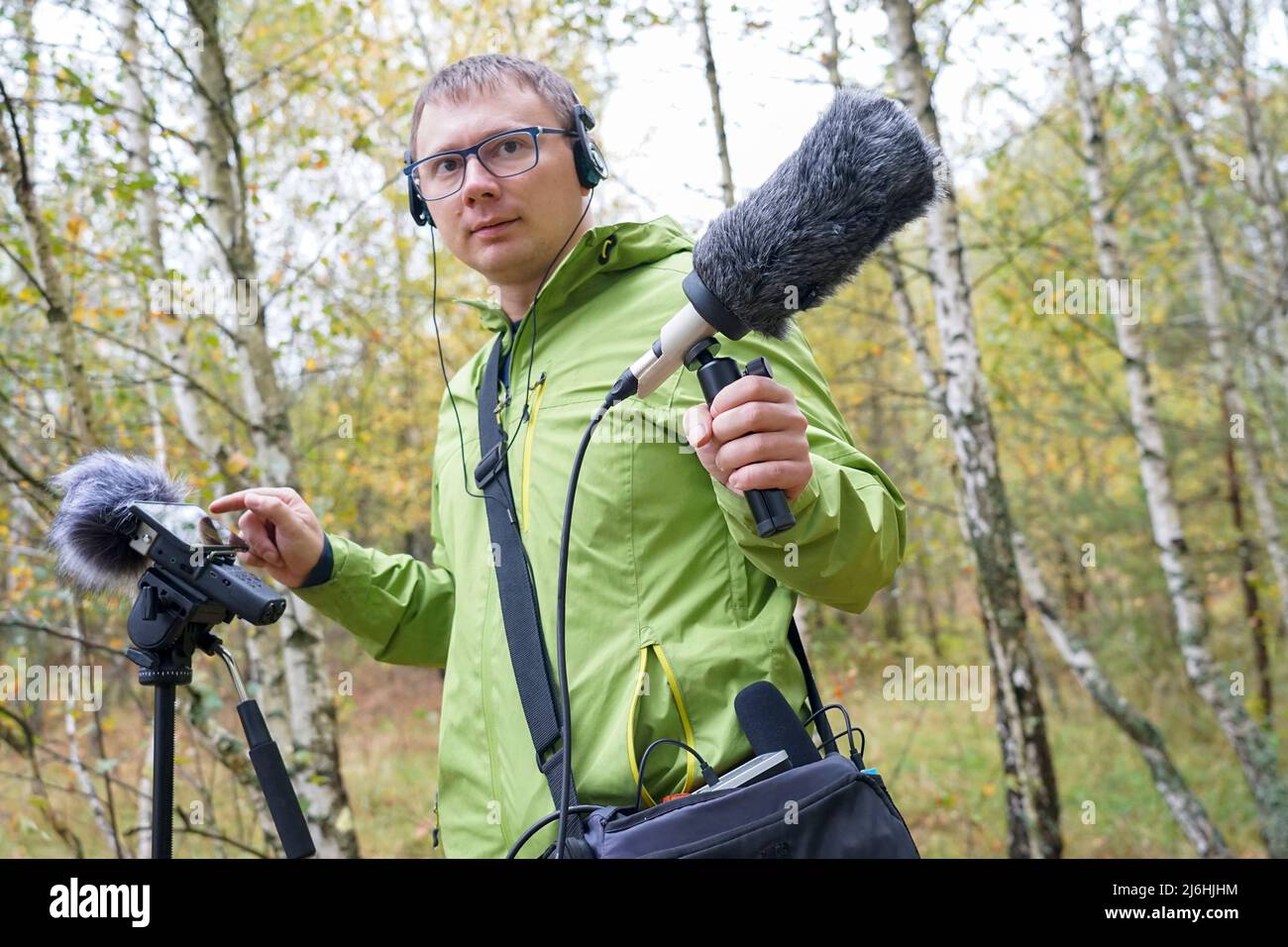 The guy with Shotgun Condenser Microphone and headphones is recording ...