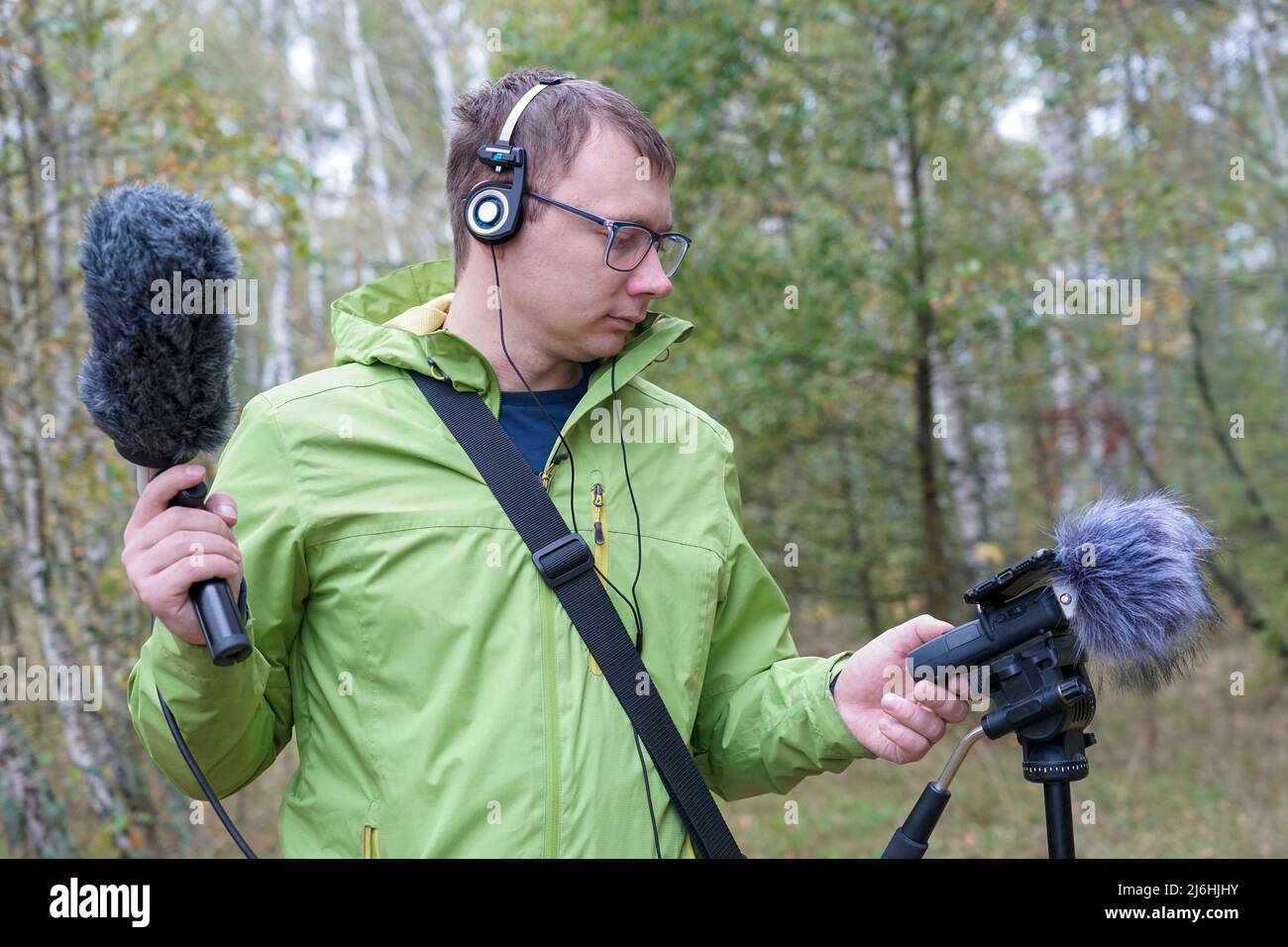The guy with Shotgun Condenser Microphone and headphones is recording ...
