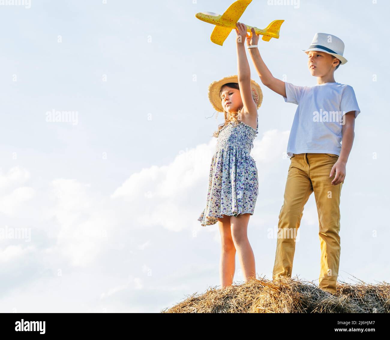 Portrait of children boy and girl playing outdoors. Light sunny day ...