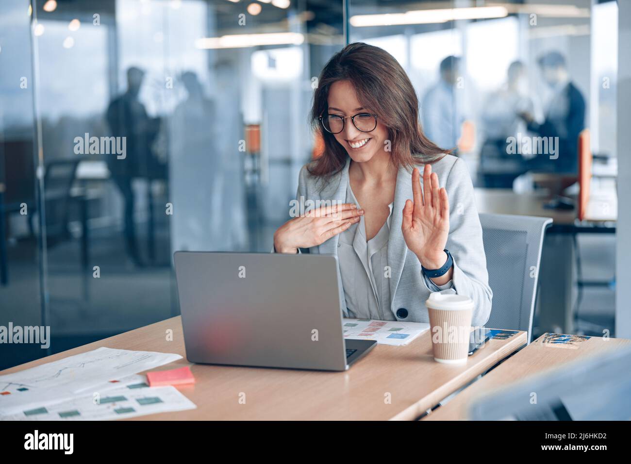 Confident deaf businesswoman communicating in video call with client at ...