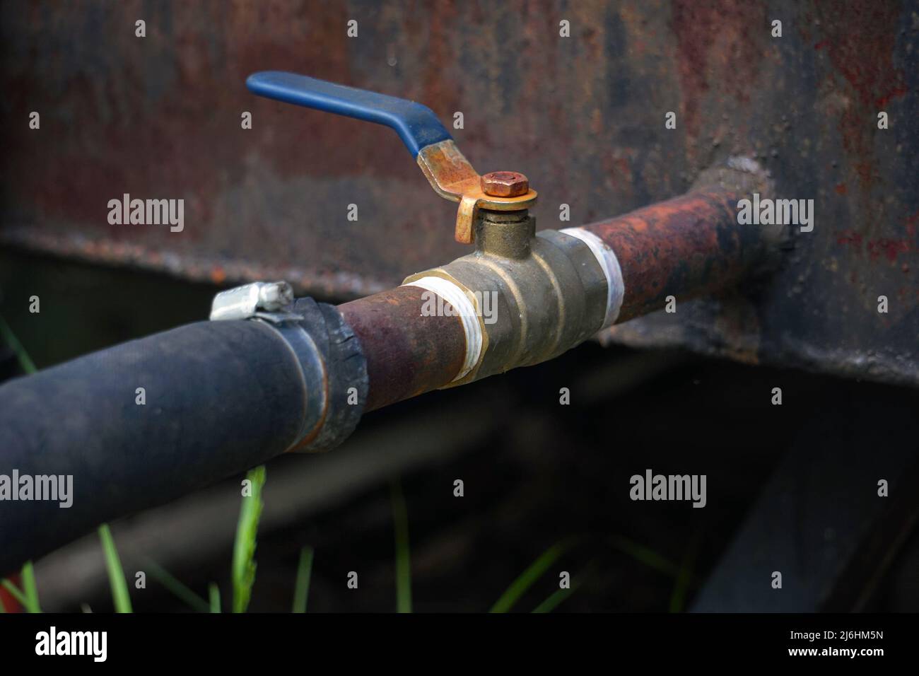 An old ball valve with a handle on a rusty tank Stock Photo - Alamy