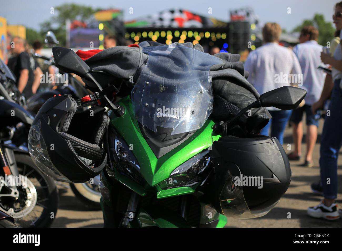 Two helmets hanging on a motorcycle sportbike Kawasaki Stock Photo - Alamy