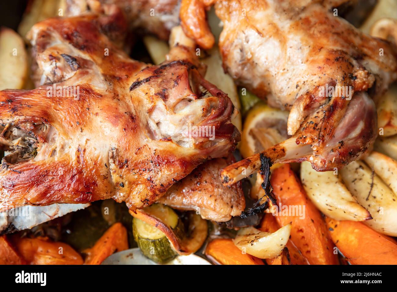 Lamb leg with bone baked with potato and herb in oven. Traditional ...