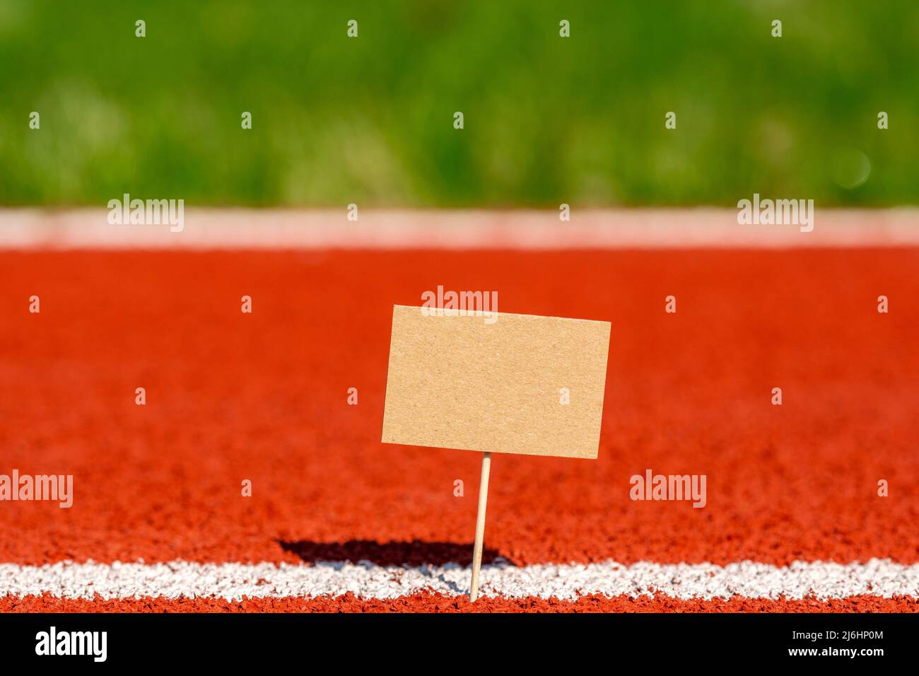 Blank mini paper pointer on a running track. Copy space Stock Photo - Alamy