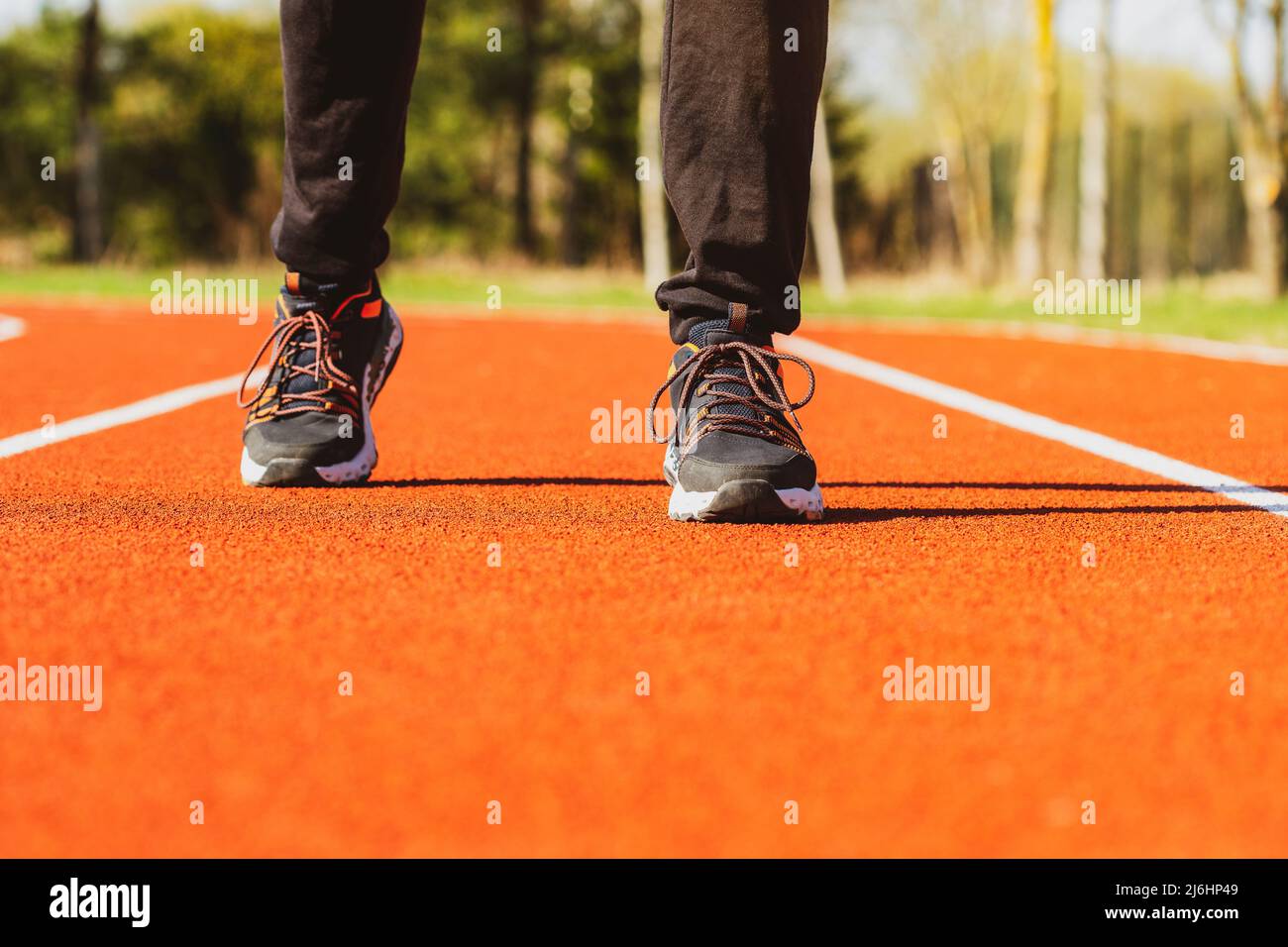 Sportsman practicing jogging in the stadium, outside. Walking on a running track. Morning ...