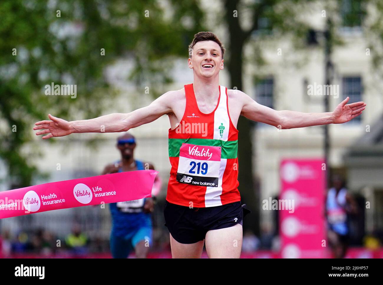 Ellis Cross crosses the finish line to win the men's race during the ...