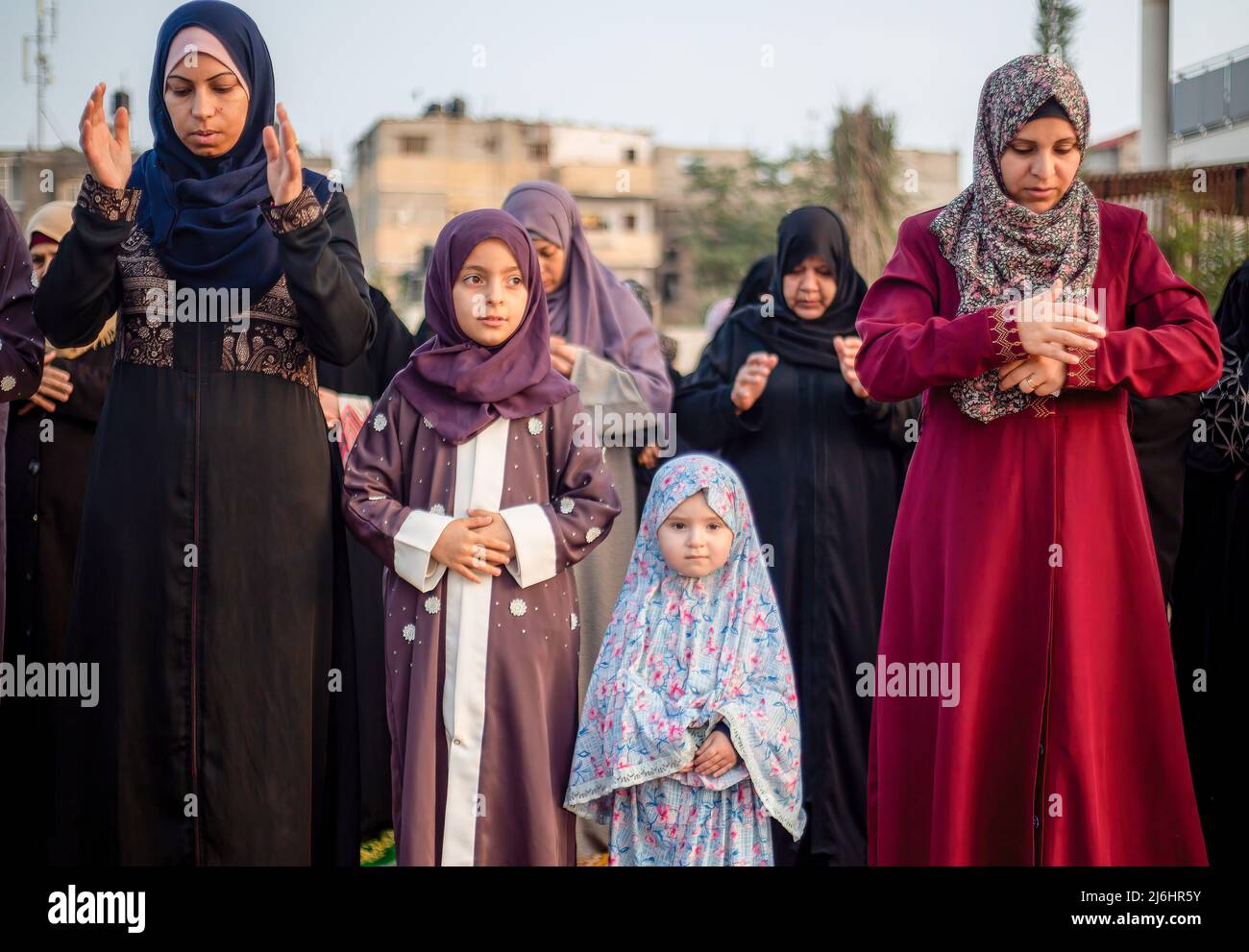 Palestinian Muslim children and women perform the Eid al-Fitr prayer at ...