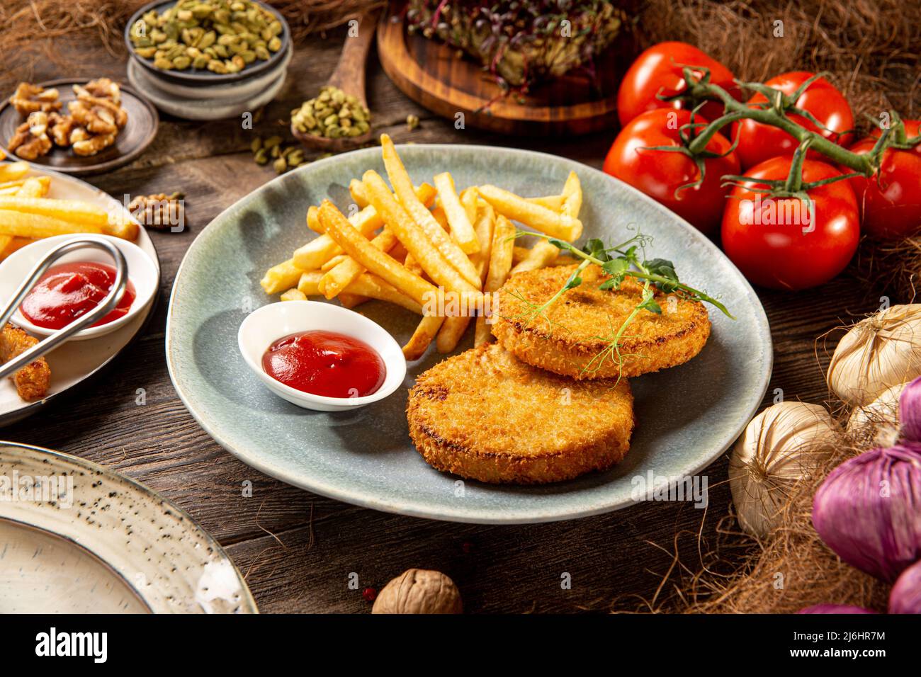 Portion of breaded fried cutlets with potato fries Stock Photo - Alamy