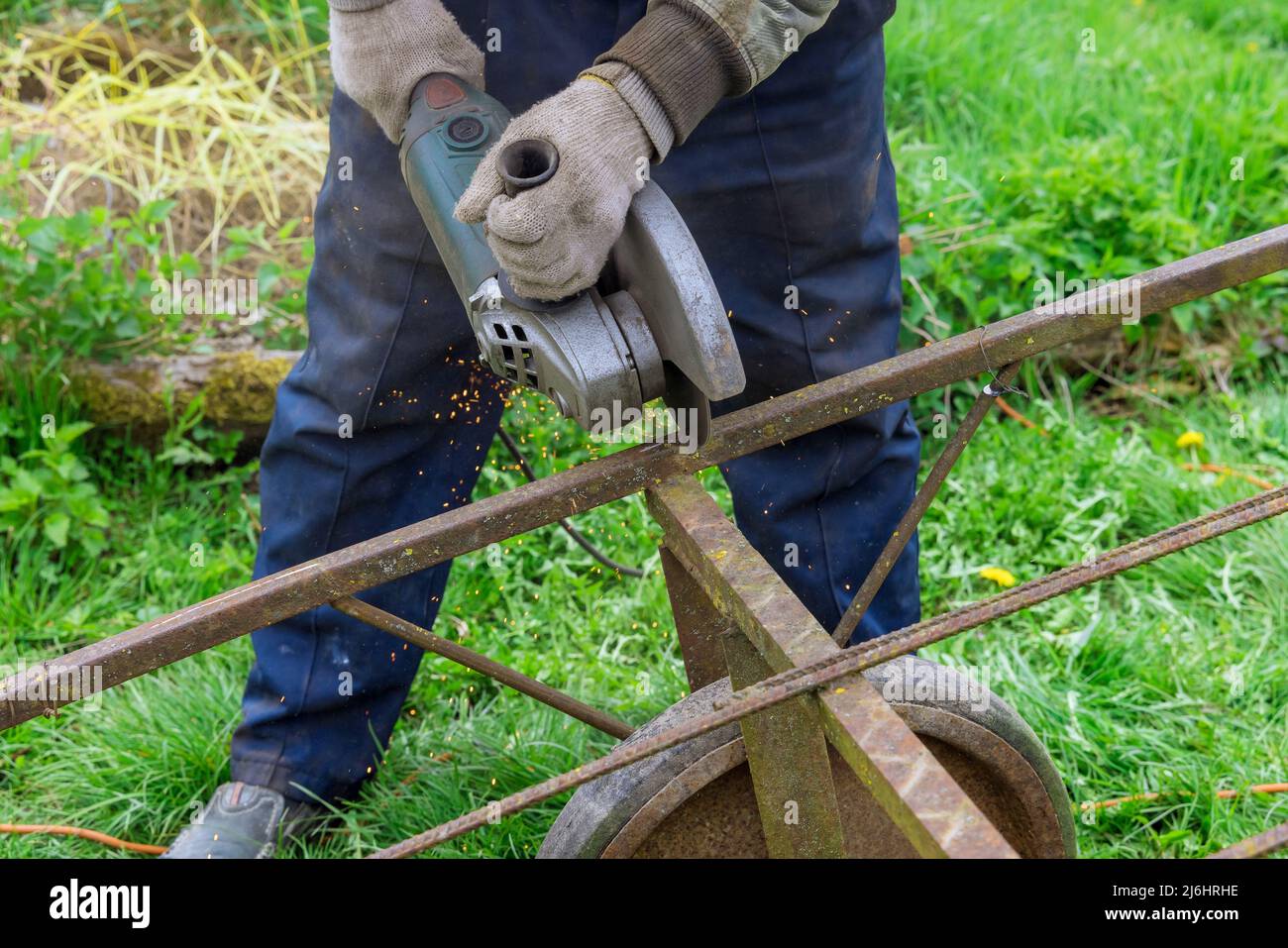 Worker cuting a metal with a hands saw in circular blade Stock Photo ...