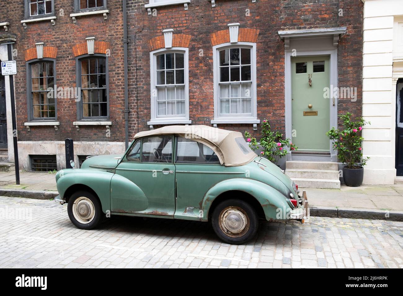 Morris Minor convertible car parked in street and doors windows house ...