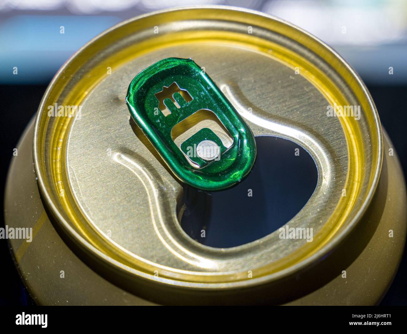 Opened beverage can with green pull tab golden surface Stock Photo - Alamy
