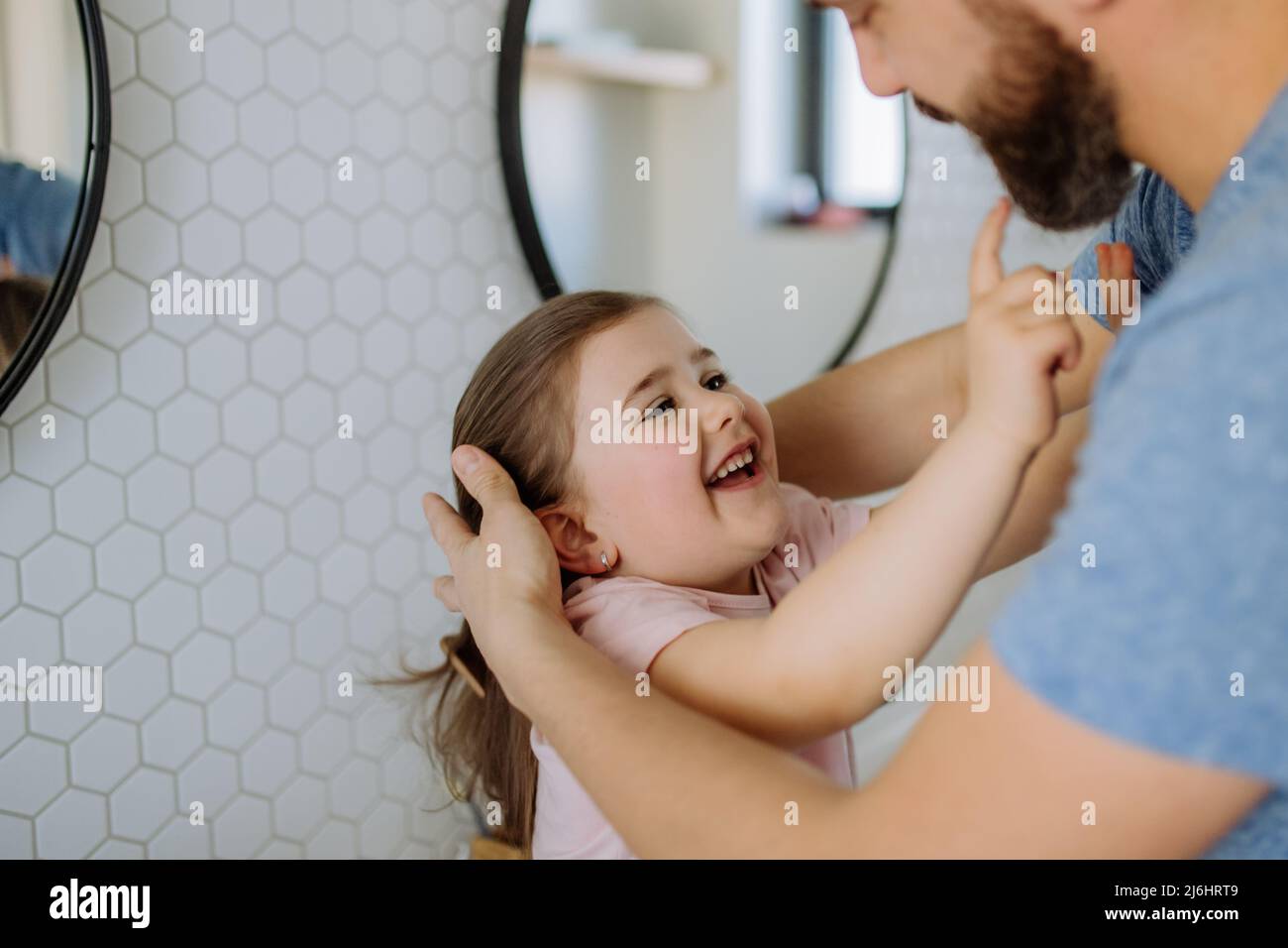 Father checking his daughter's teeth in bathroom, morning routine concept Stock Photo - Alamy