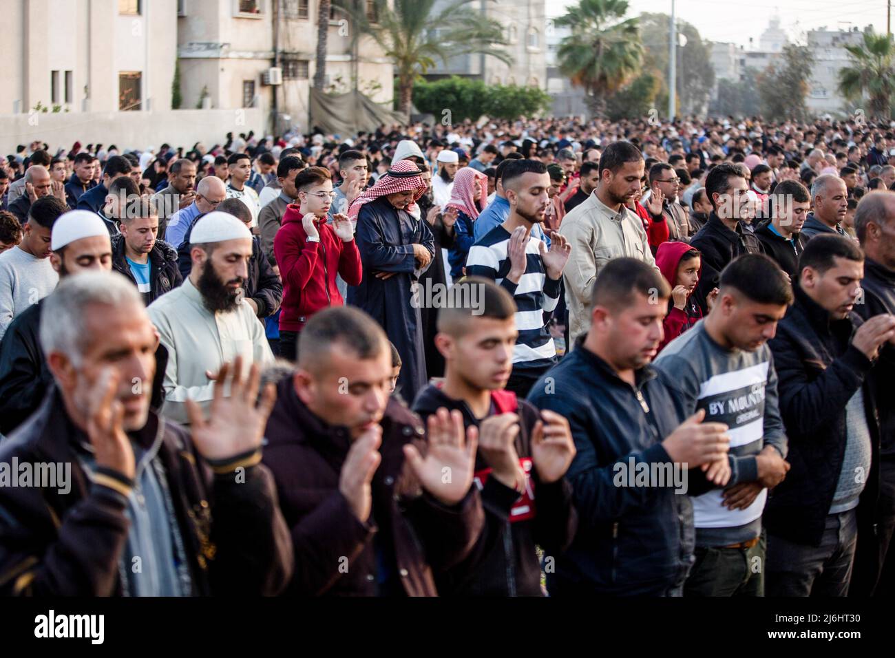 Palestinian Muslims perform Eid al-Fitr prayers at sunrise marking the ...