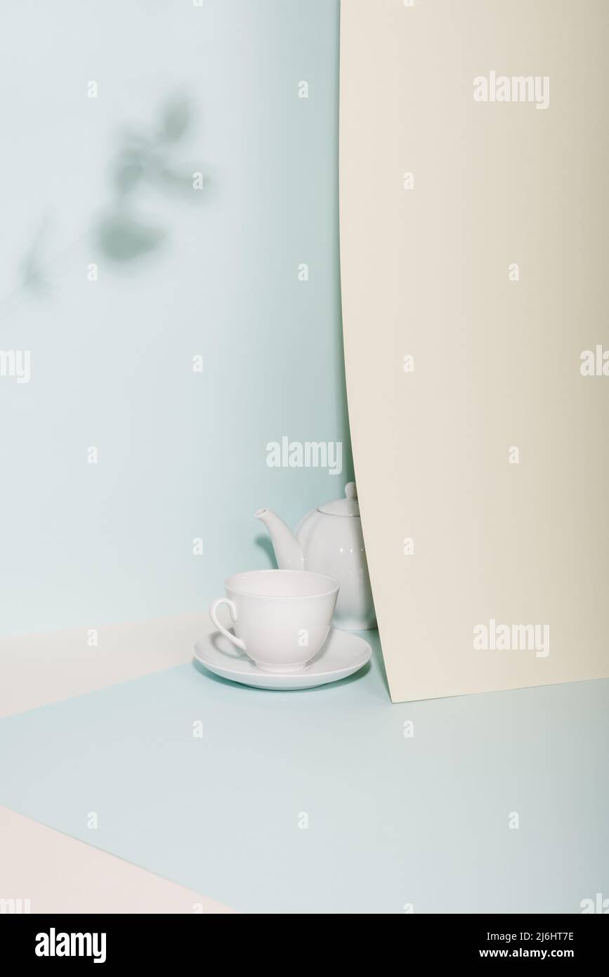 Tea cup and teapot on the table. Light background Stock Photo - Alamy
