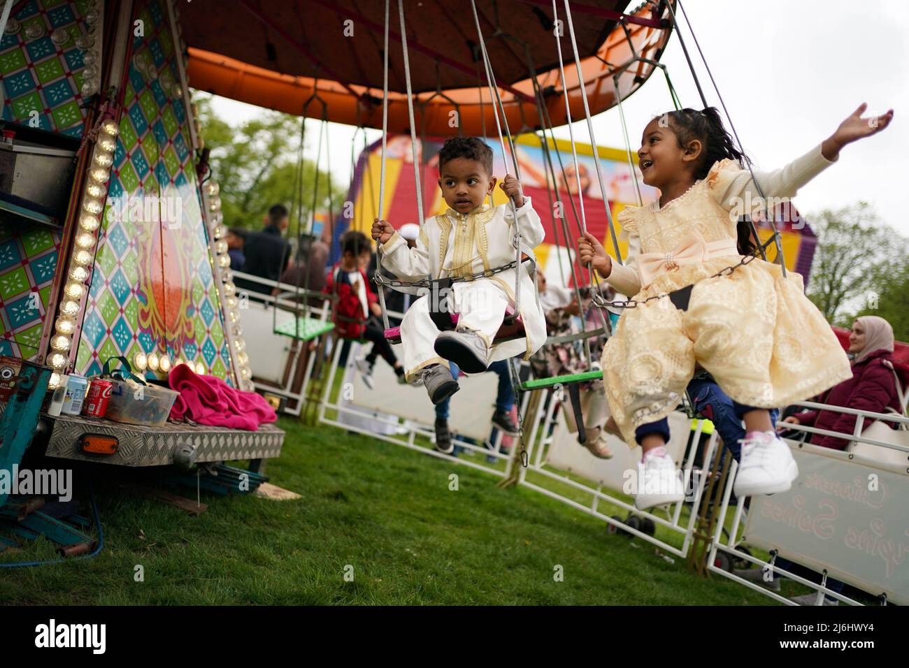 Children enjoy theme park rides at a funfair at Small Heath Park in ...