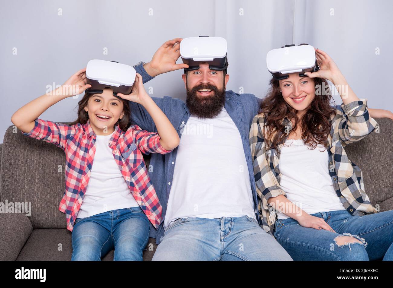 happy parents with kid girl use modern technology at home. mom dad and ...