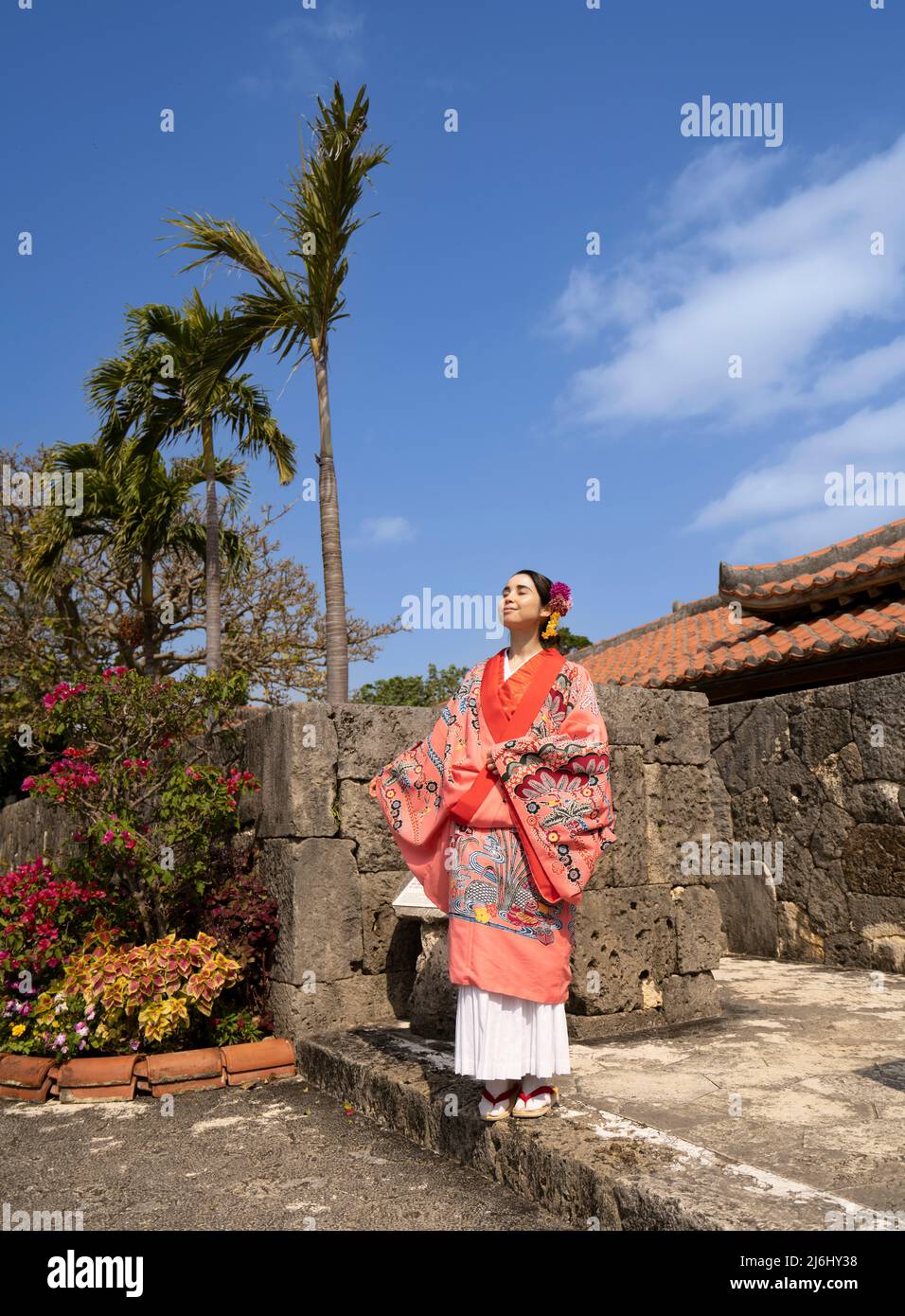 Woman wearing traditional ryusou dress at Okinawa World theme park in ...