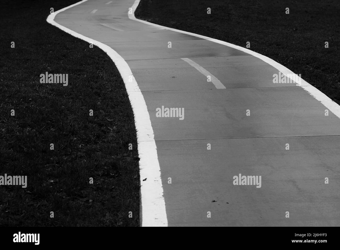 Concrete bicycle trail winding thru the college campus Stock Photo - Alamy