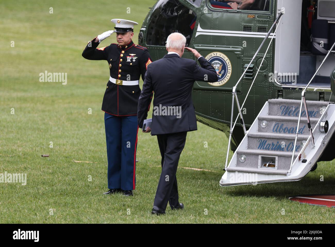United States President Joe Biden salutes the Marine Guard before ...