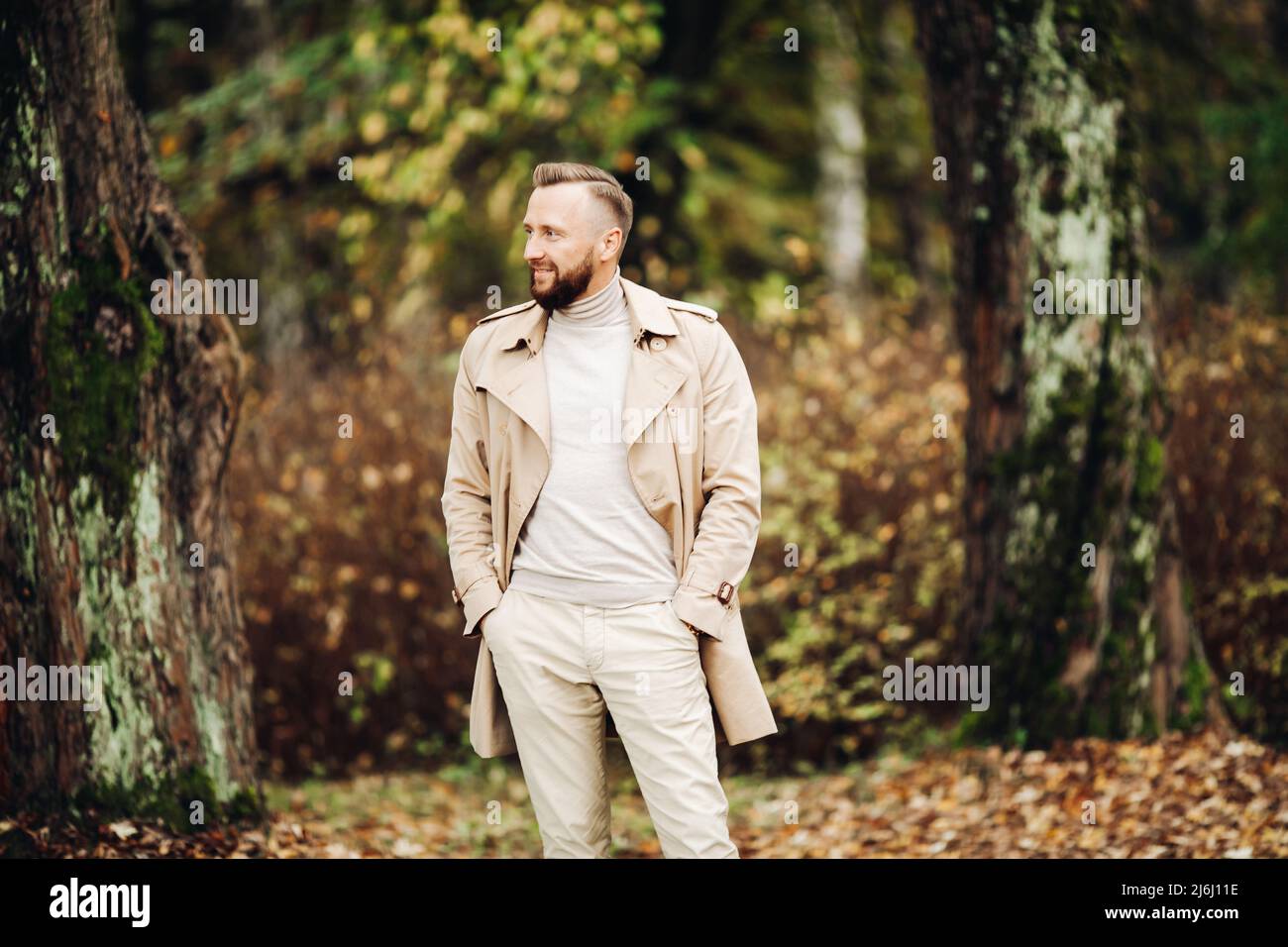 Portrait of a man in the forest with autumn leaves behind him Stock ...