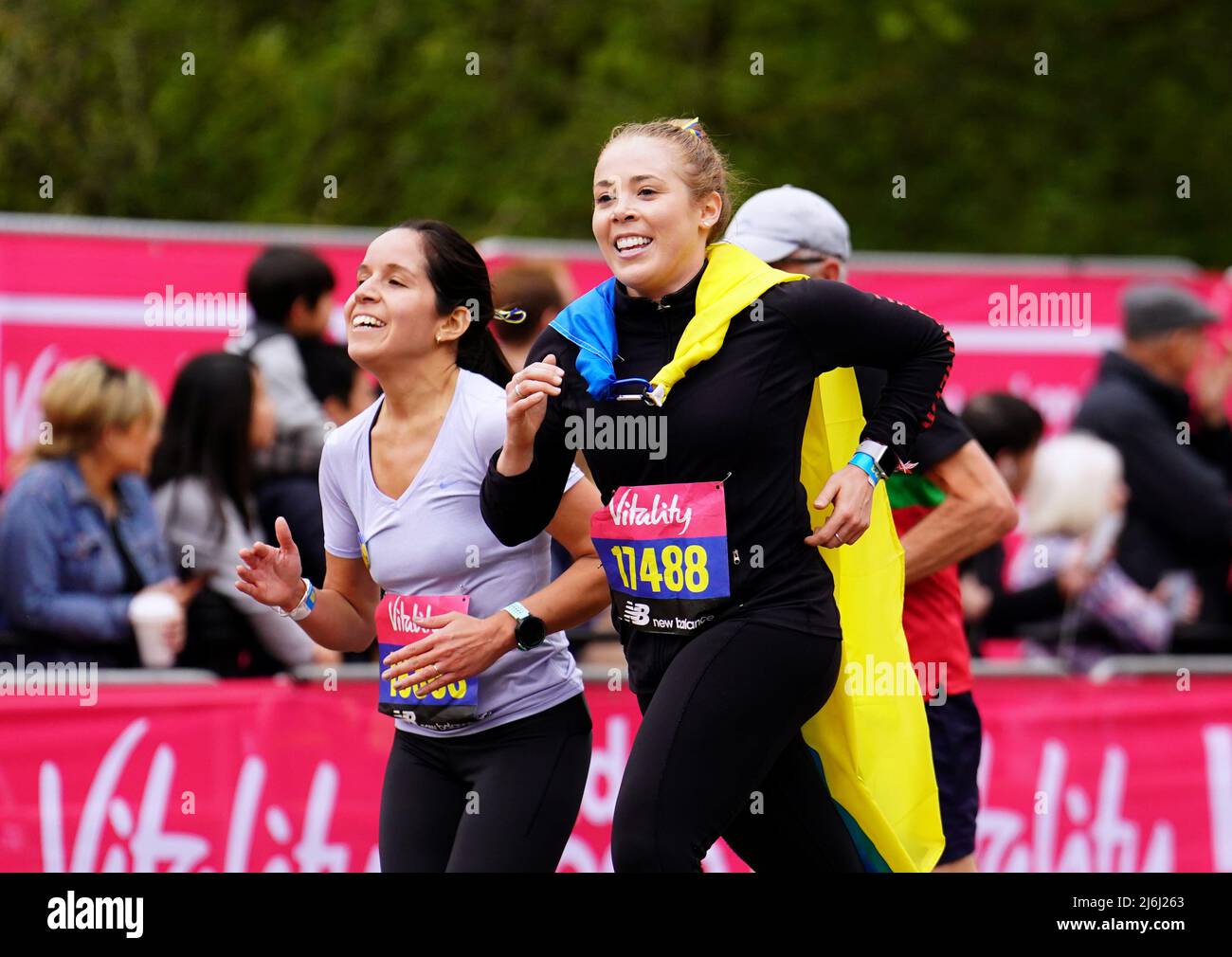 A runner wears a Ukrainian flag as they compete in the Run For Ukraine ...