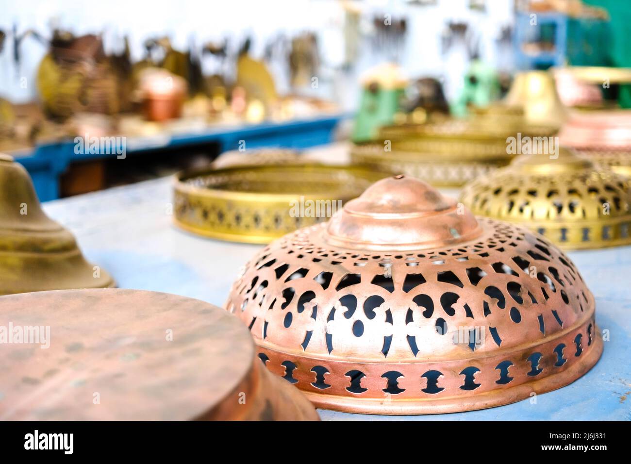 Different finished pieces of brass in a craft factory Stock Photo - Alamy