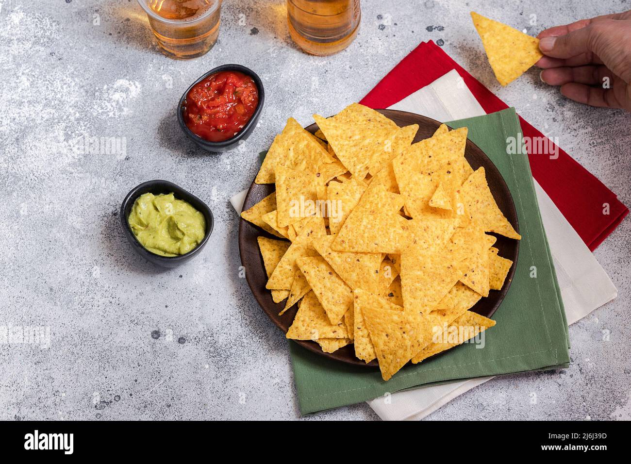 The most famous Mexican snack, nachos with guacamole, red chilli sauce ...