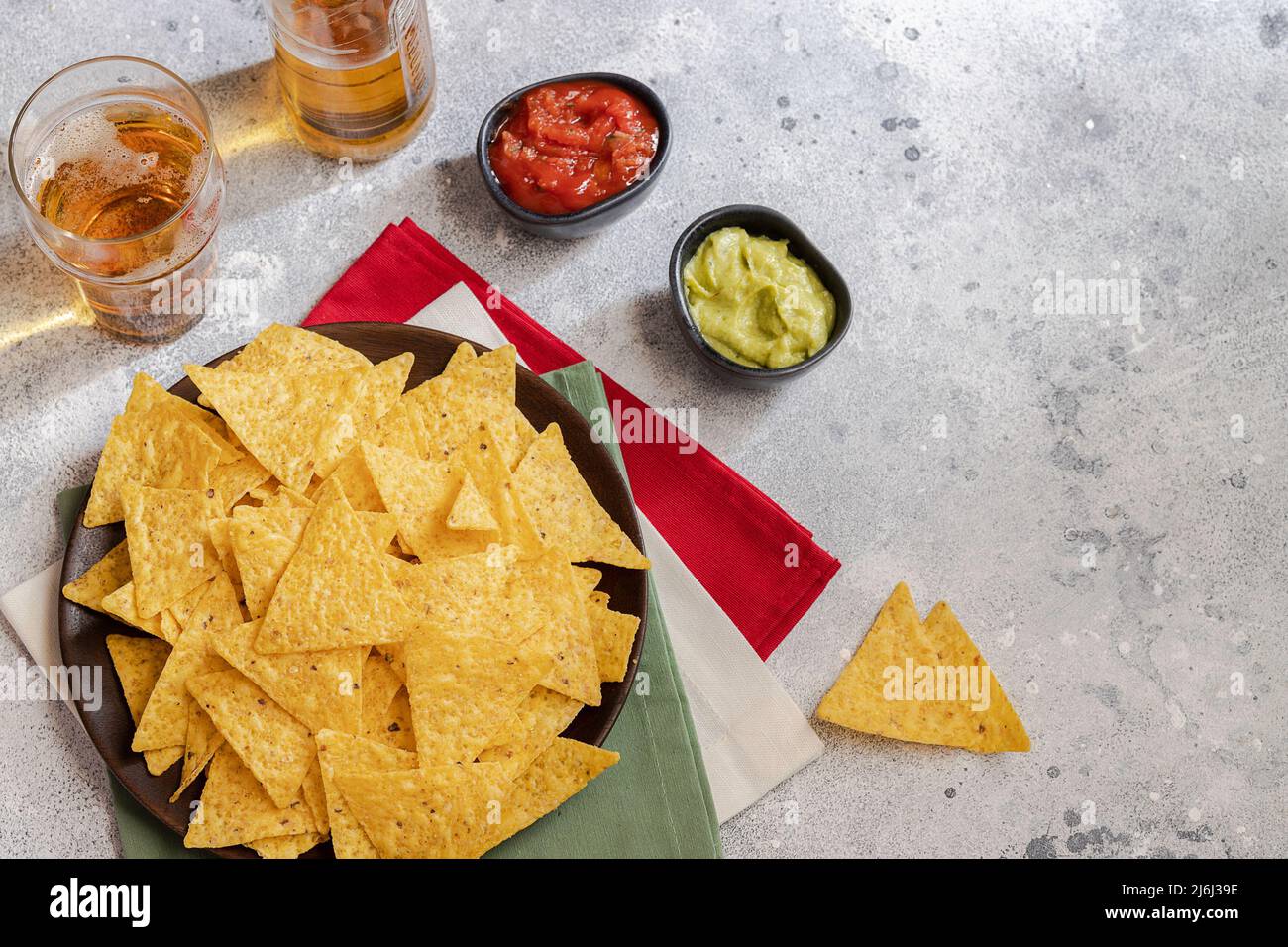 The most famous Mexican snack, nachos with guacamole, red chilli sauce ...