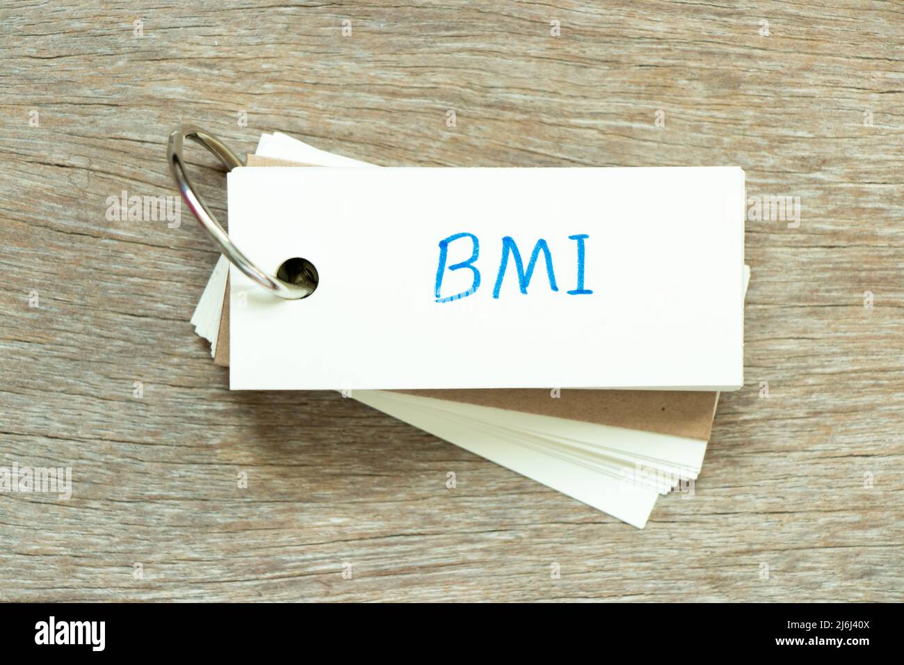 Flash card with handwriting word BMI (abbreviation of body mass index ...