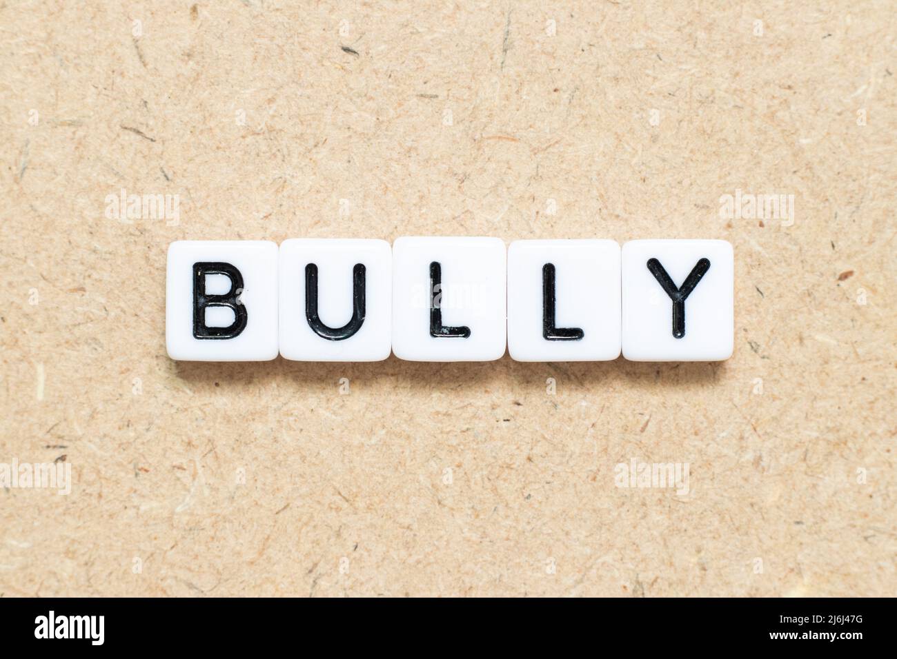 White tile alphabet letter with word bully on wood background Stock ...
