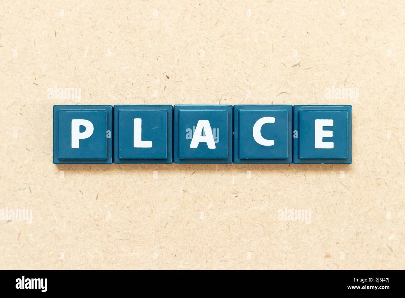 Tile alphabet letter in word place on wood background Stock Photo - Alamy
