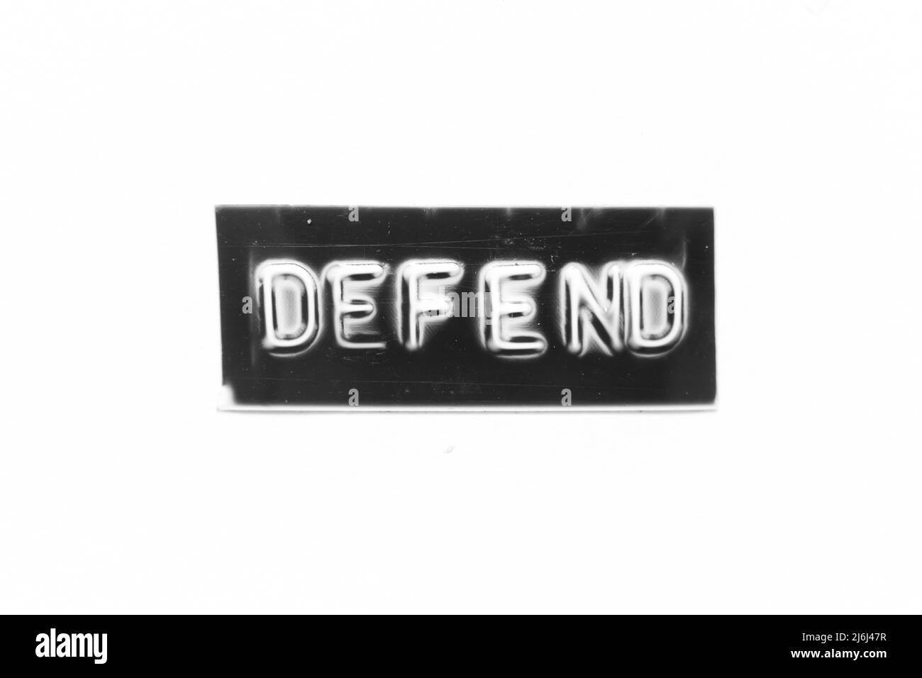 Black color banner that have embossed letter with word defend on white ...