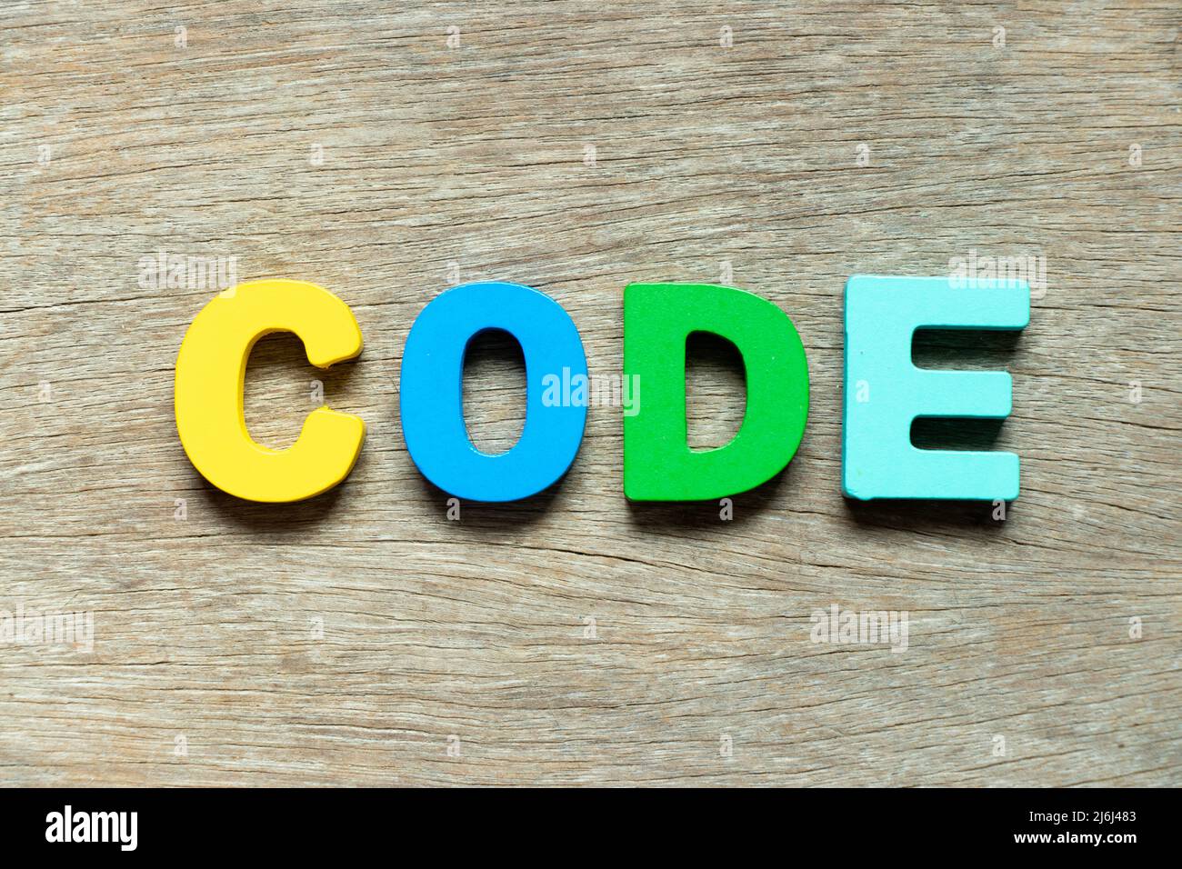 Color alphabet letter in word code on wood background Stock Photo - Alamy