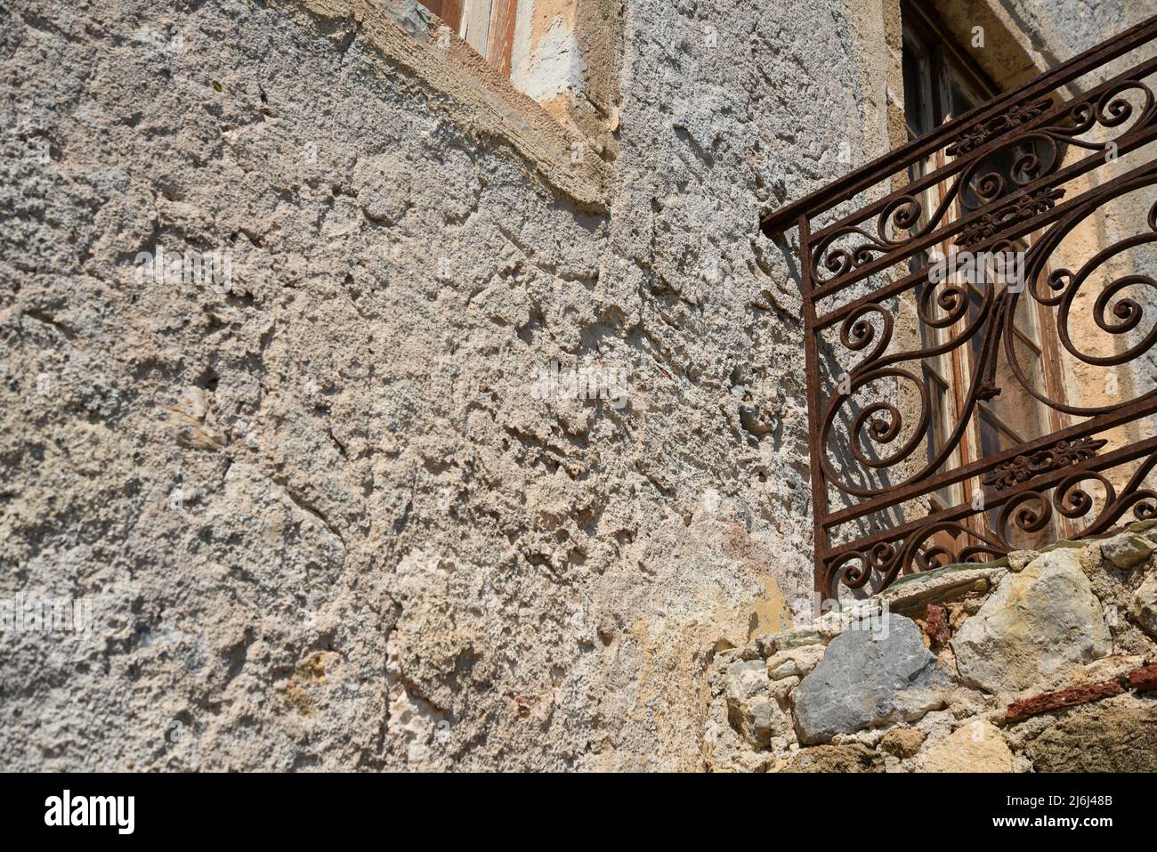 Old rural house handcrafted stone wall and a balcony with a rusty ...