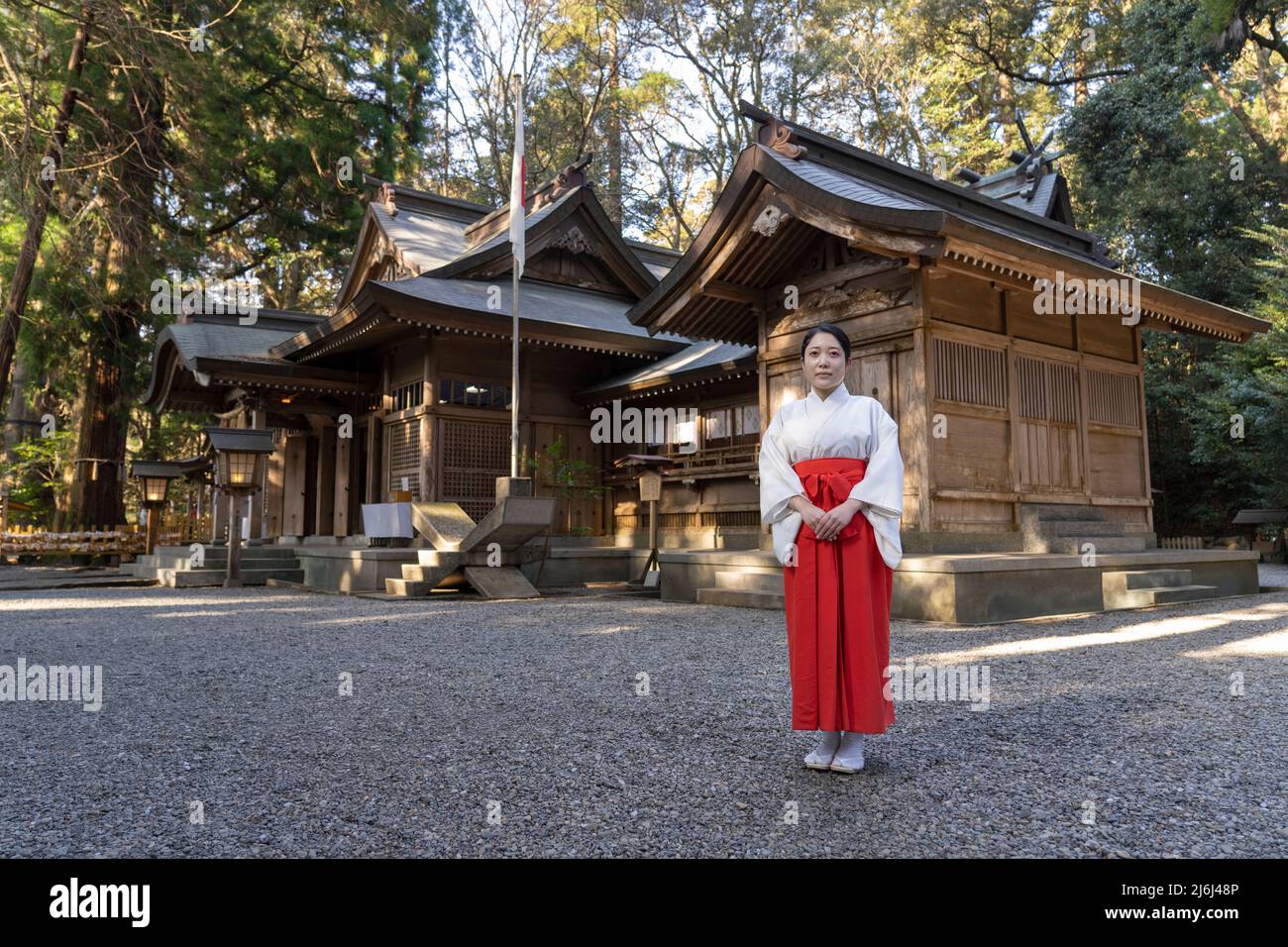 A miko (巫女), or shrine maiden at Takachiho Shrine, a Shinto shrine ...