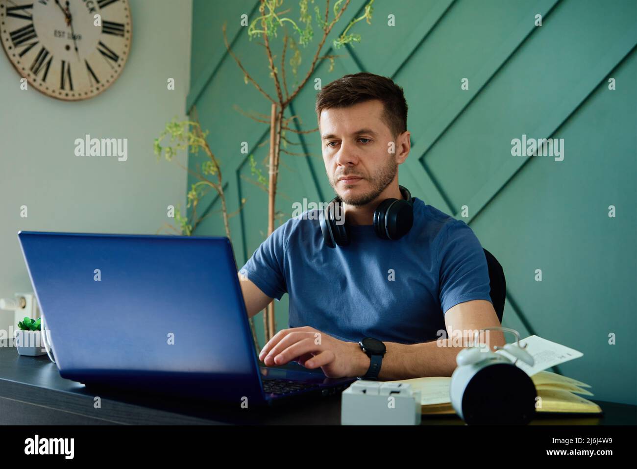 Man working remotely at home office with laptop Stock Photo - Alamy