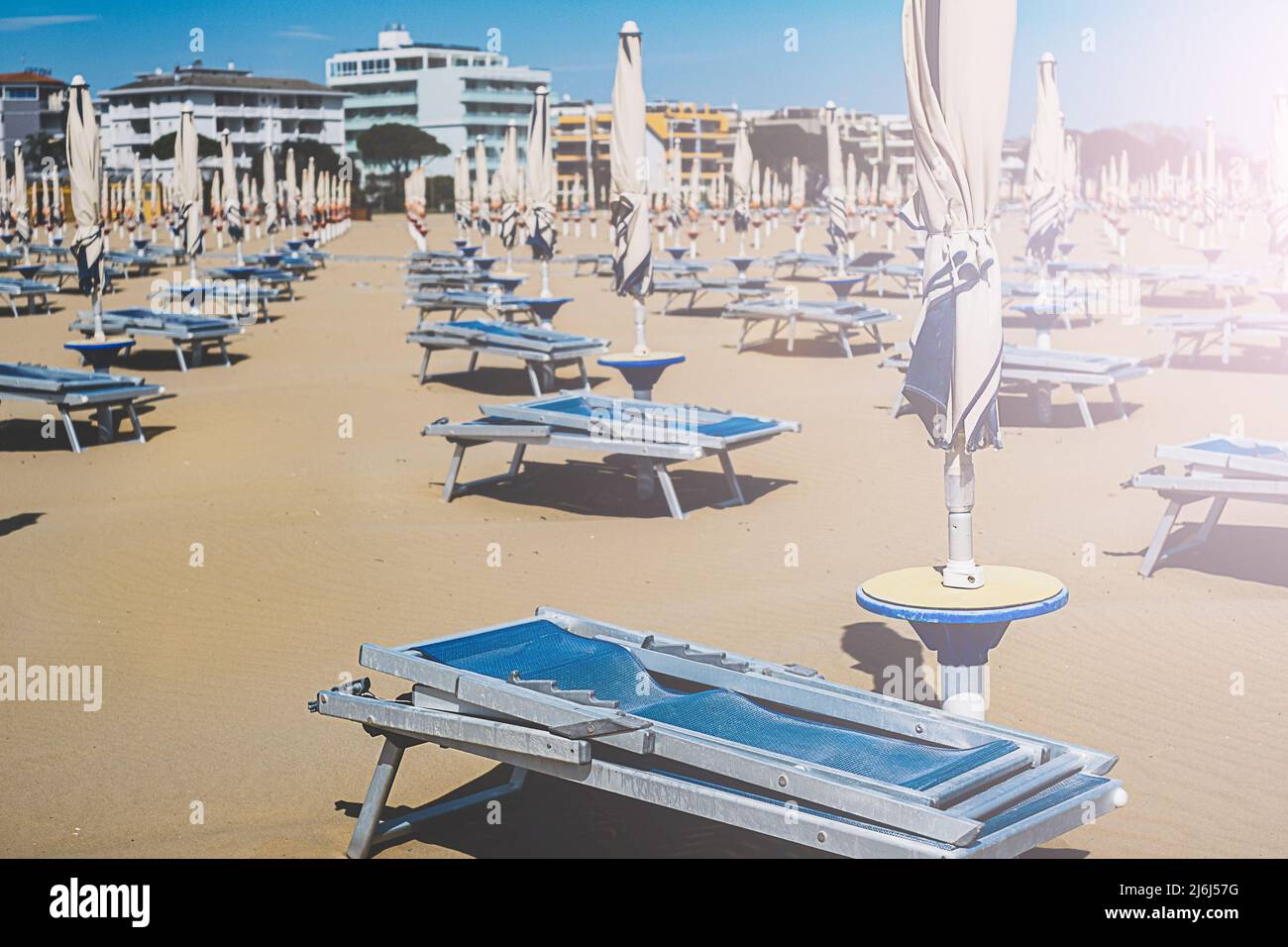 Umbrellas and sunbeds on the beach in Italy. The beach season is ready ...