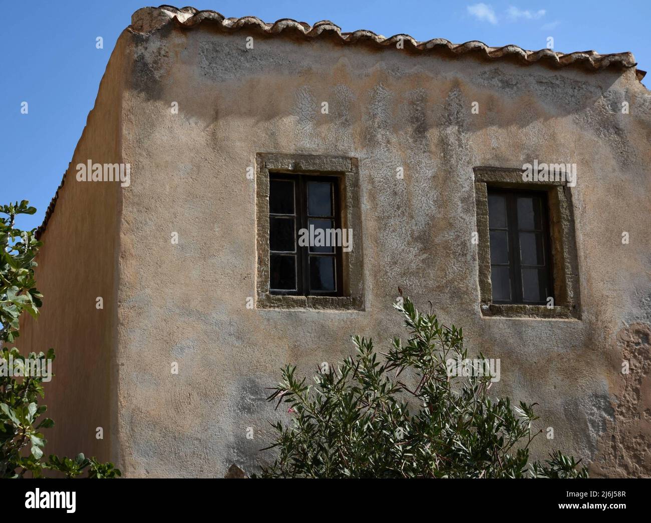 Old traditional Venetian style house with a stucco wall and a clay tile ...